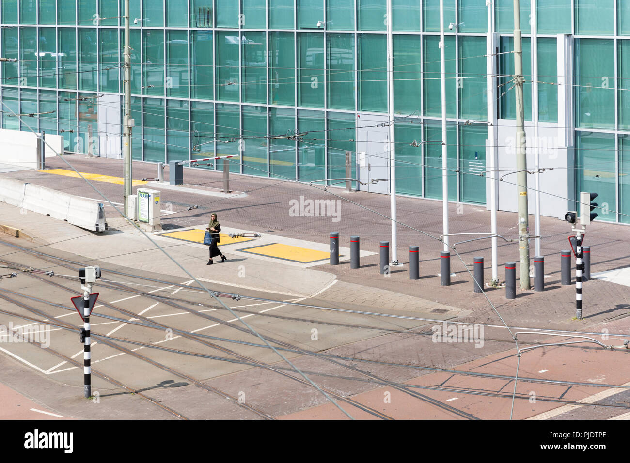 Girl crossing rotterdam inner city intersection Stock Photo - Alamy