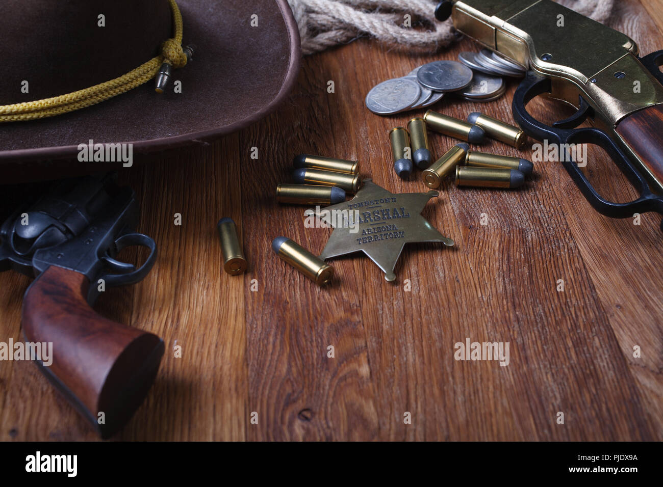Wild west rifle, ammunition and sheriff badge on wooden table Stock ...
