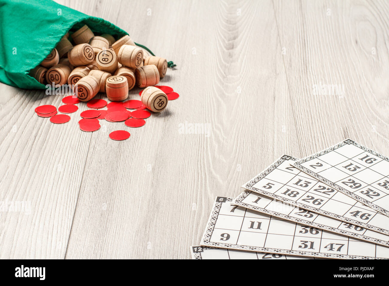 Game cards, wooden lotto barrels with green bag and red chips for a ...