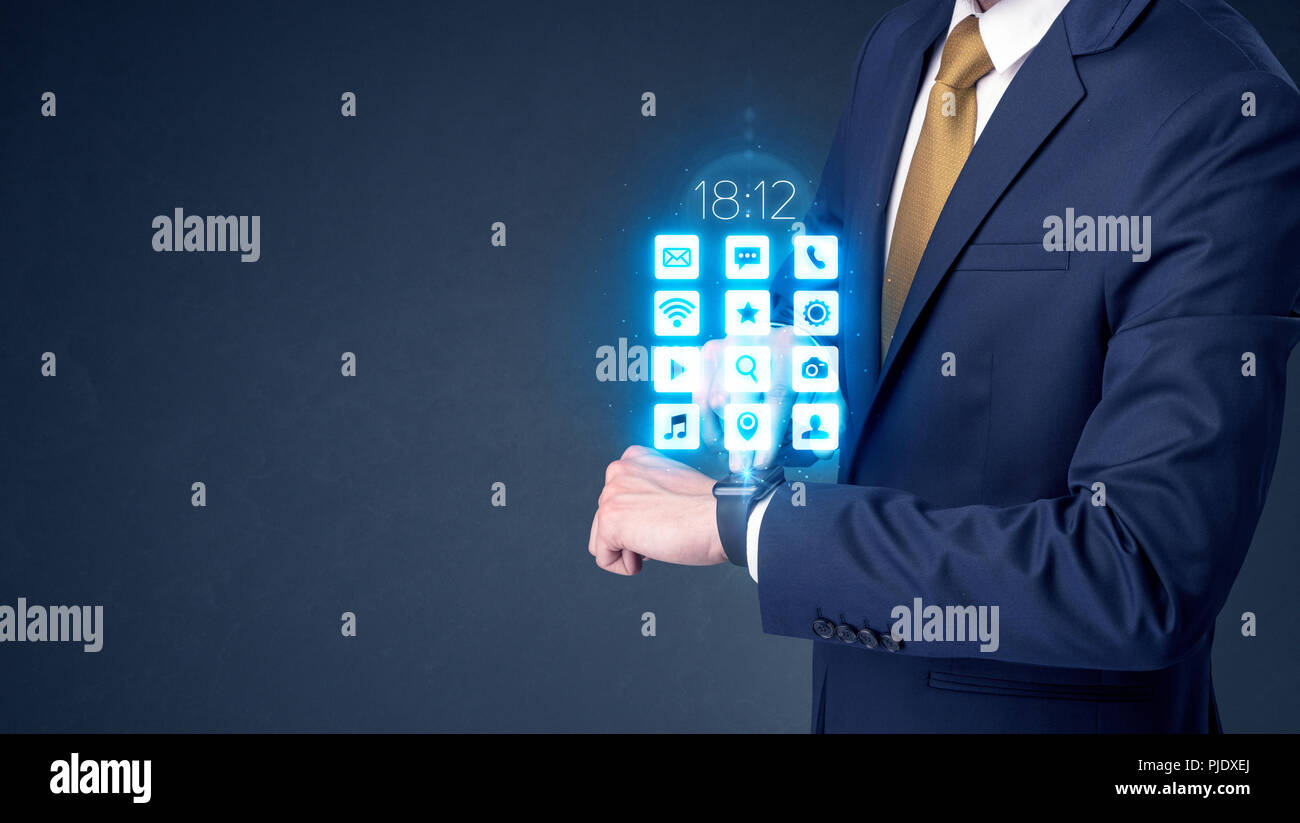 Businessman wearing smartwatch with application icons Stock Photo - Alamy