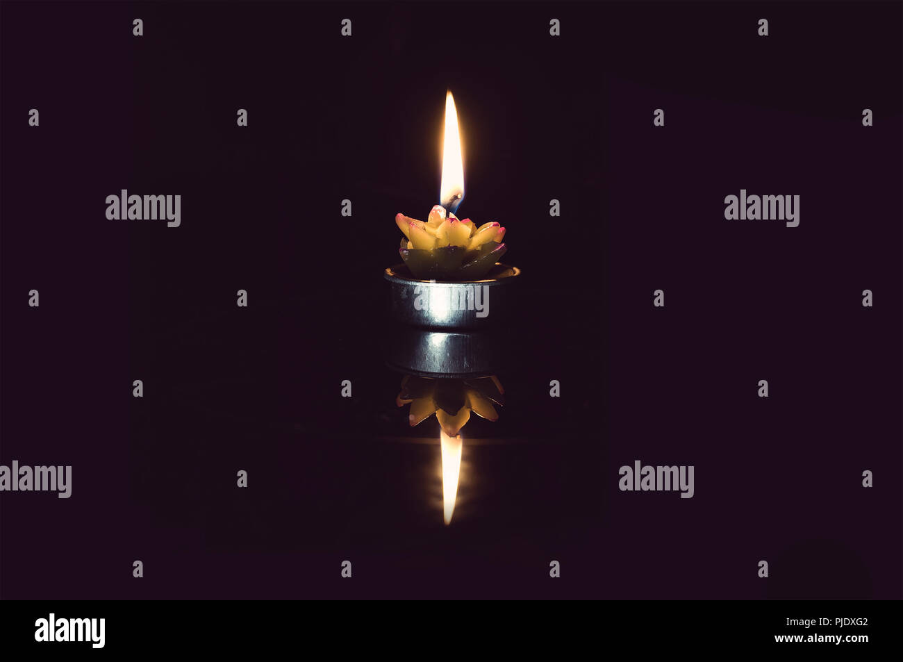 wax candle on a black background with a burning fuse Stock Photo - Alamy