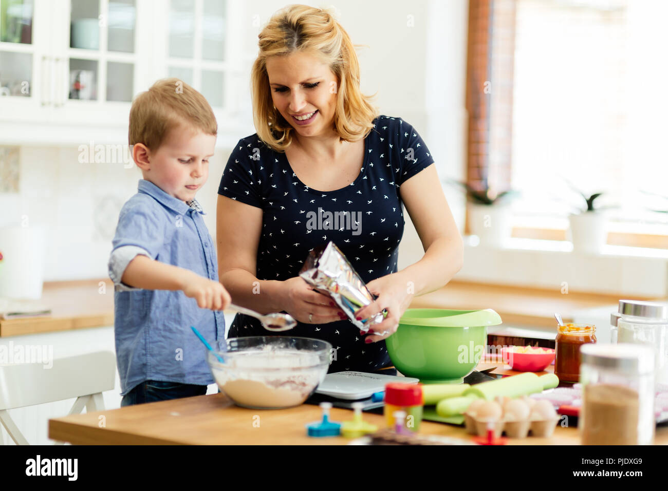 Child helping mother bake cookies Stock Photo - Alamy