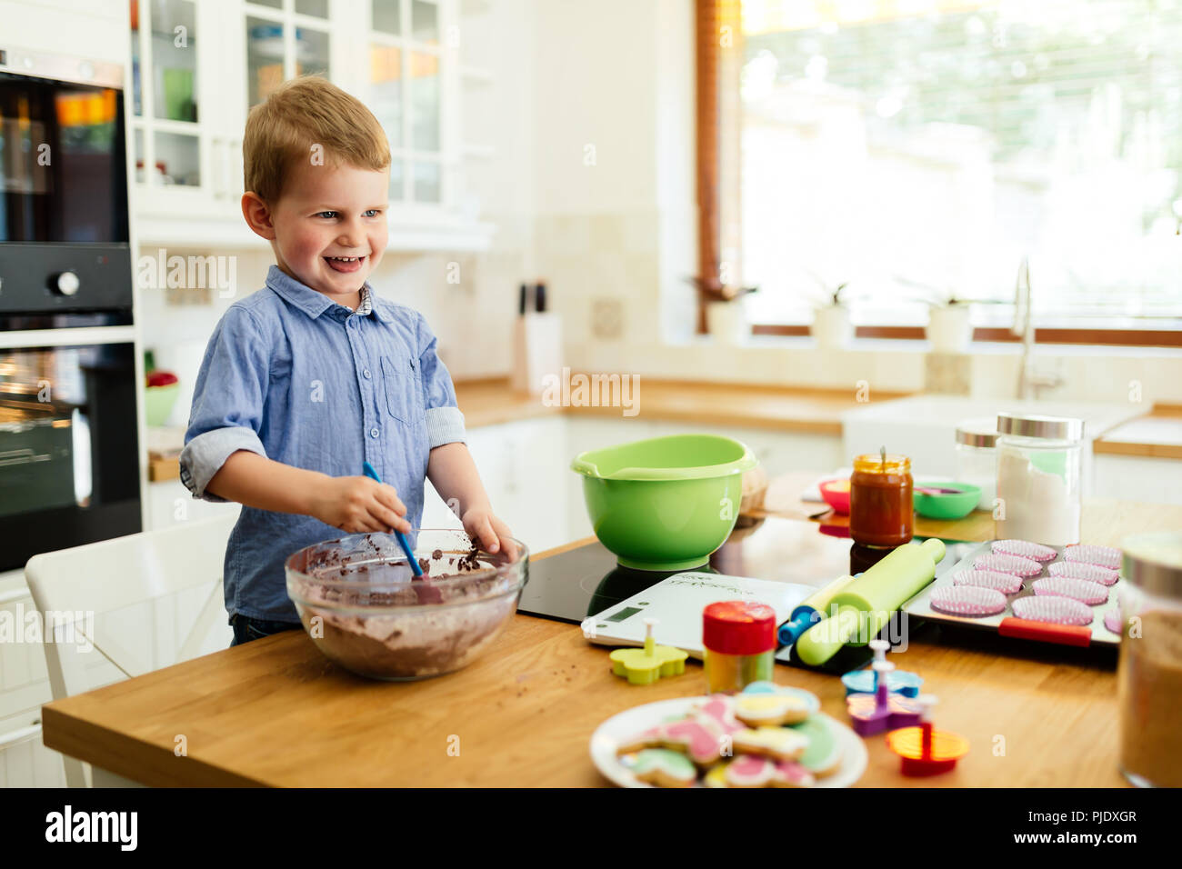 Cute child learning to become a chef Stock Photo - Alamy