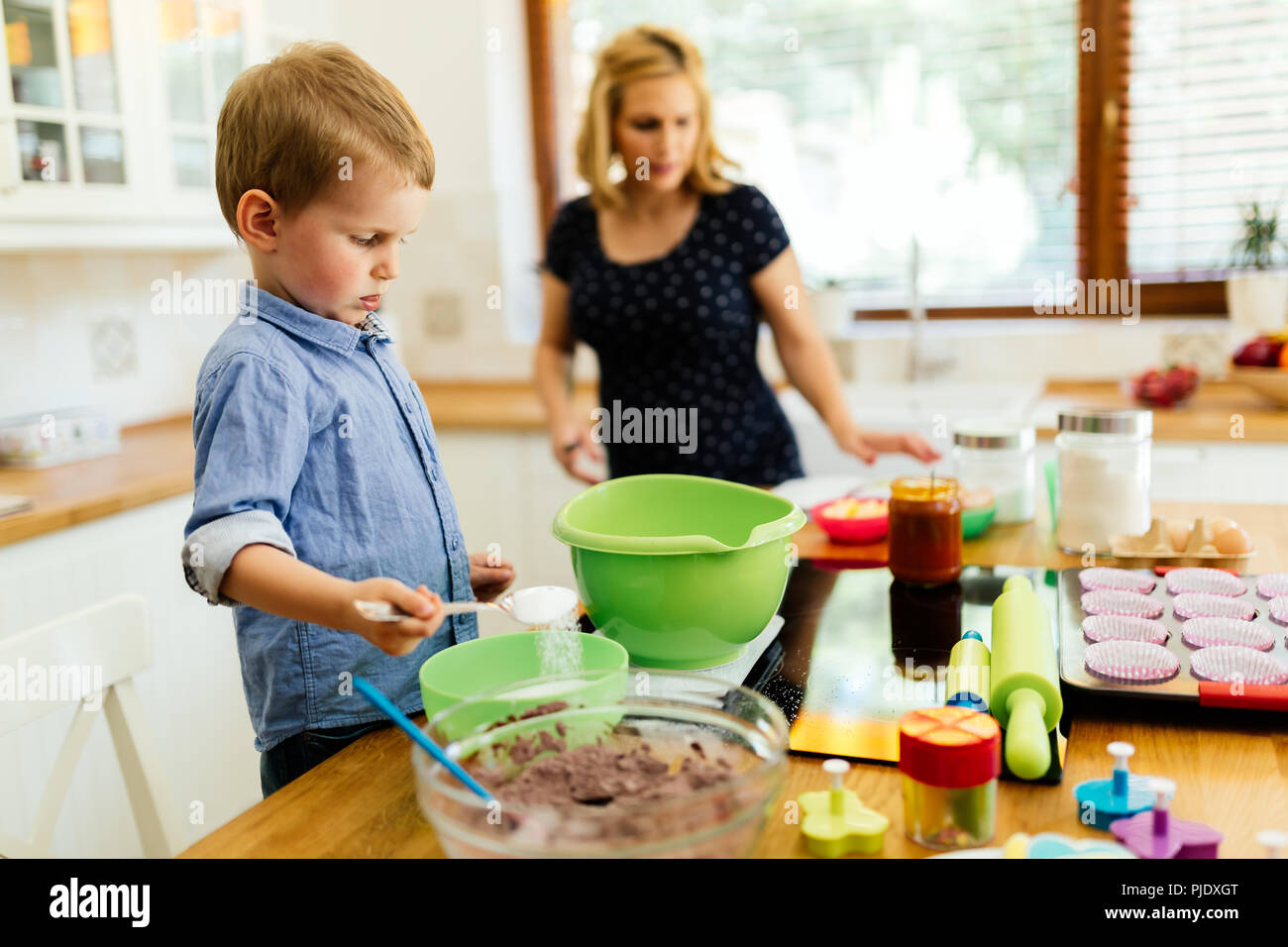 Child helping mother bake cookies Stock Photo - Alamy
