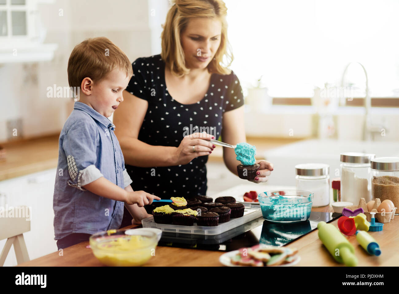 Beautiful child and mother baking Stock Photo - Alamy