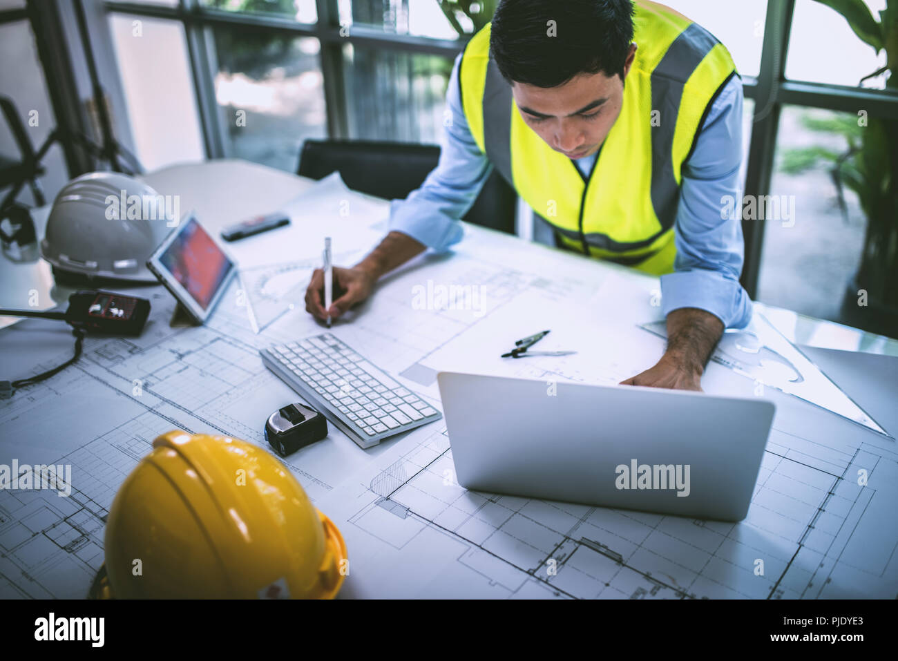 Architect working on blueprint.engineer inspective in workplace ...