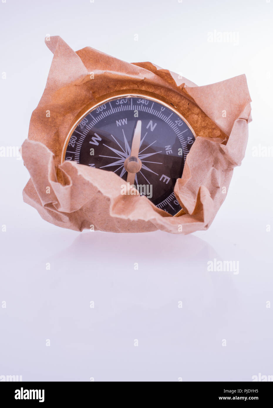 Black compass instrument wrapped in brown paper Stock Photo - Alamy
