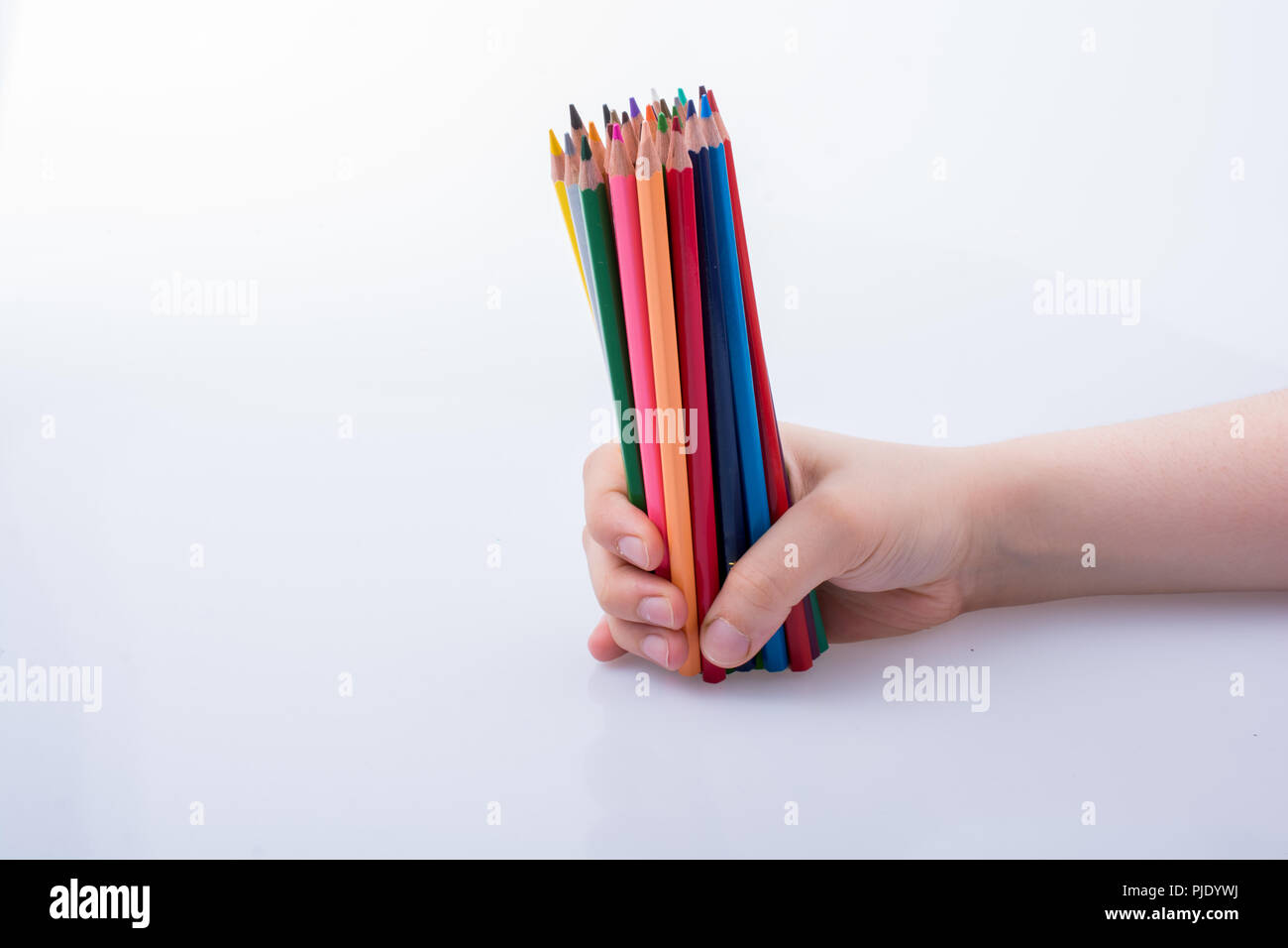 Hand holding color Pencils placed on a white background Stock Photo - Alamy