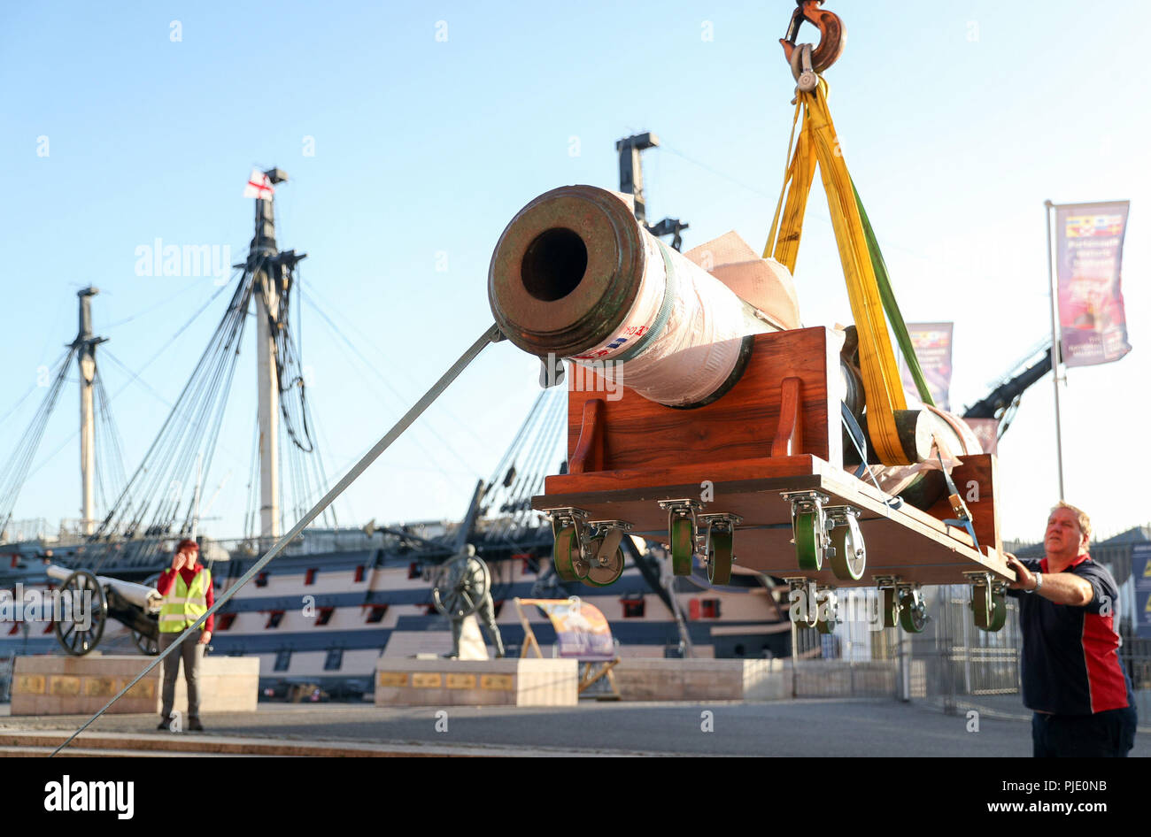 Workmen move a 42-pound cannon into position, which is the first ...