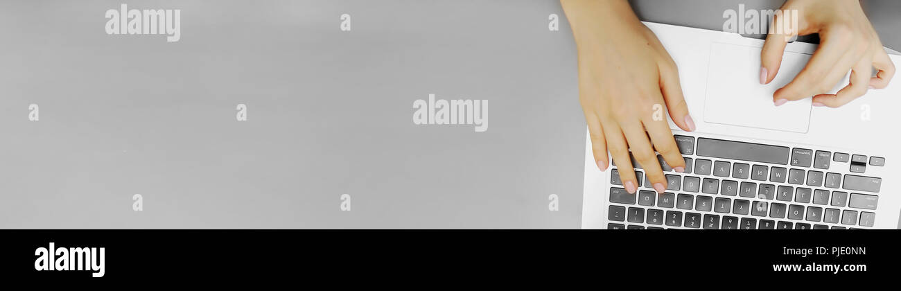 Banner of top view laptop keyboard and female hands with copyspace in ...