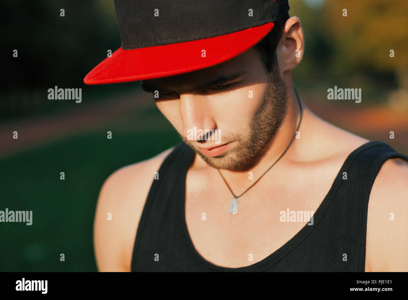 Dancer in a red cap in the park Stock Photo - Alamy