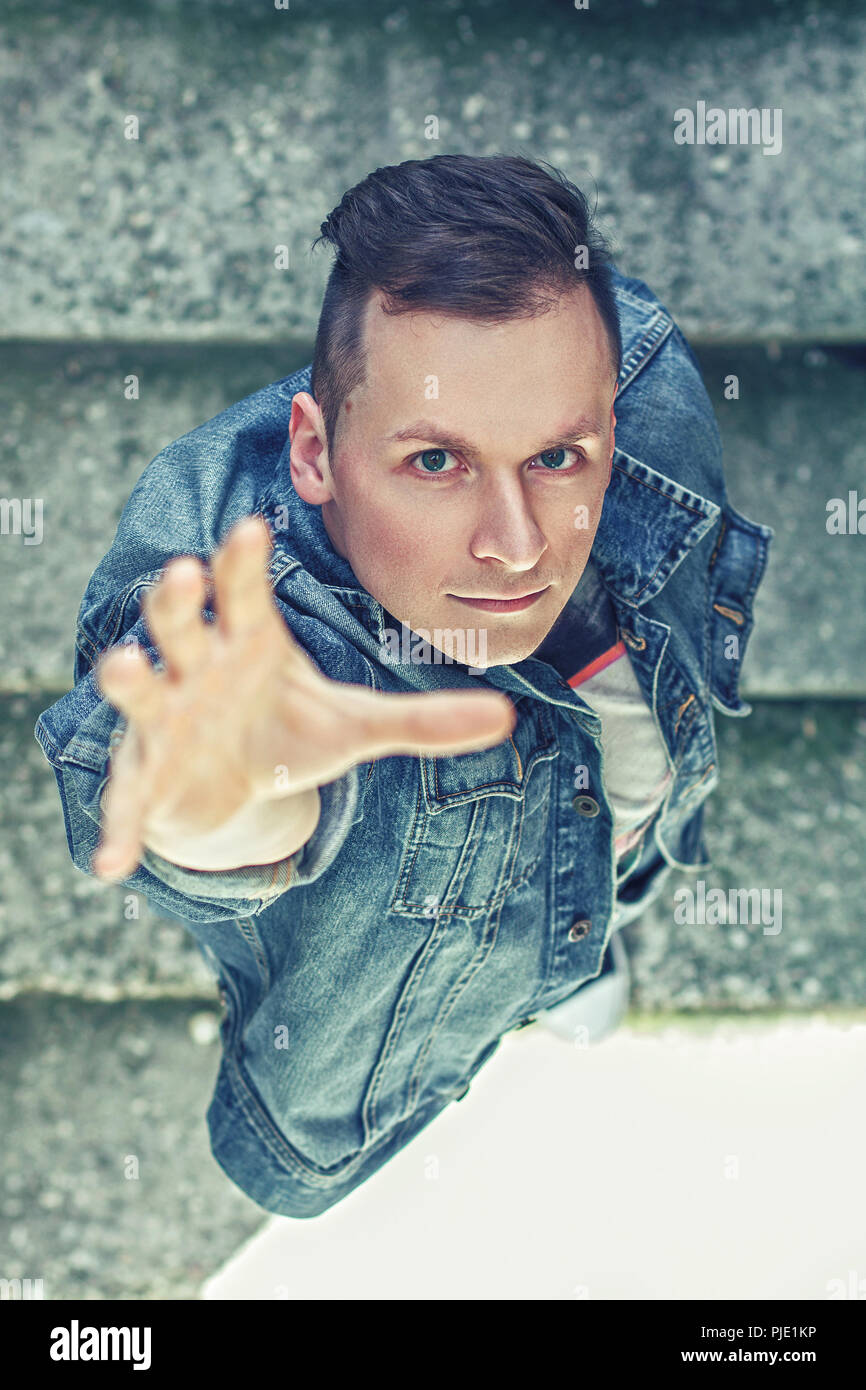 Young man grabs his hand Stock Photo - Alamy