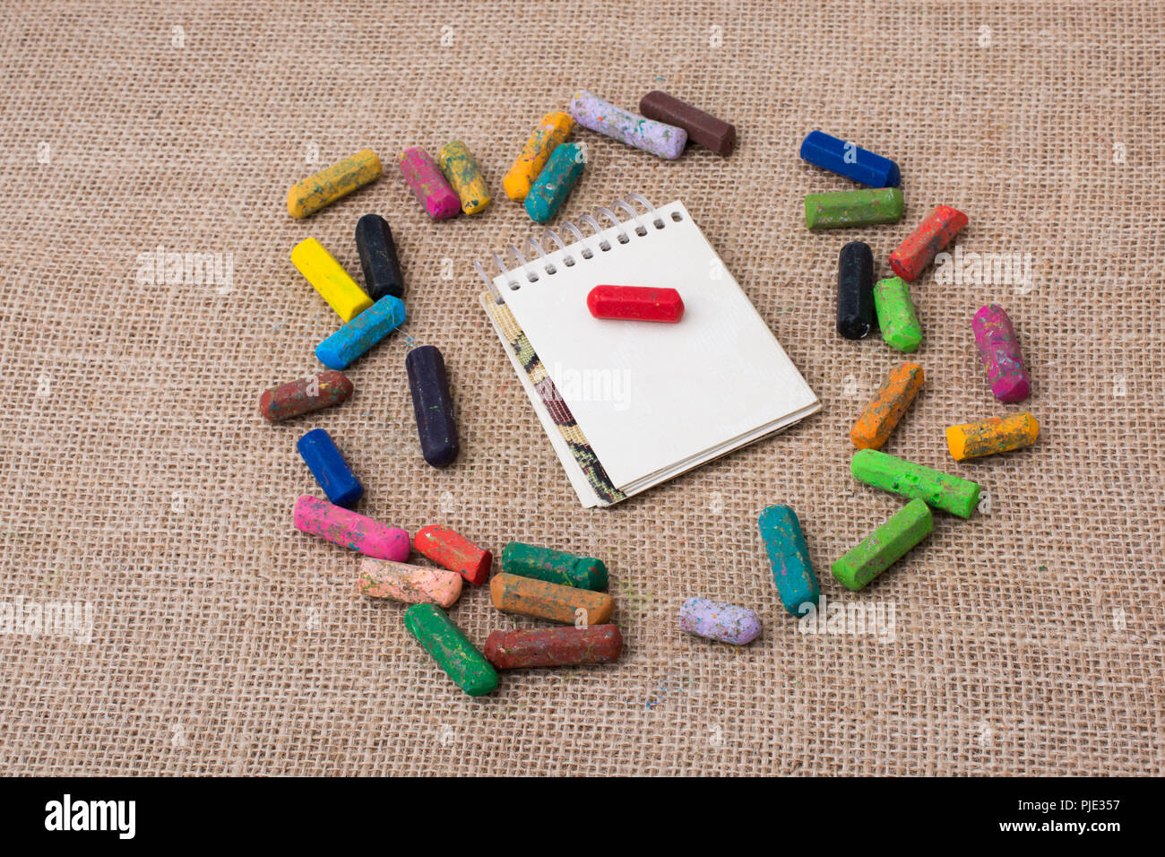 Used crayons of various color on a canvas Stock Photo - Alamy