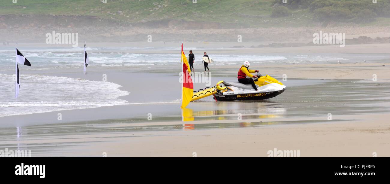 Rnli lifeguard approaching the beach on rescue jet ski hi-res stock ...