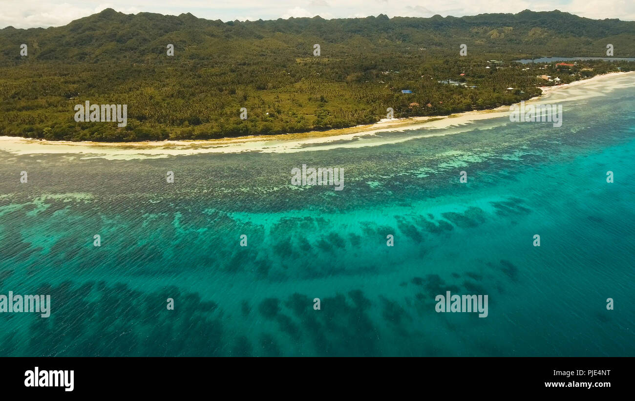 Aerial view: sea and the tropical island with beach,resort, hotels ...