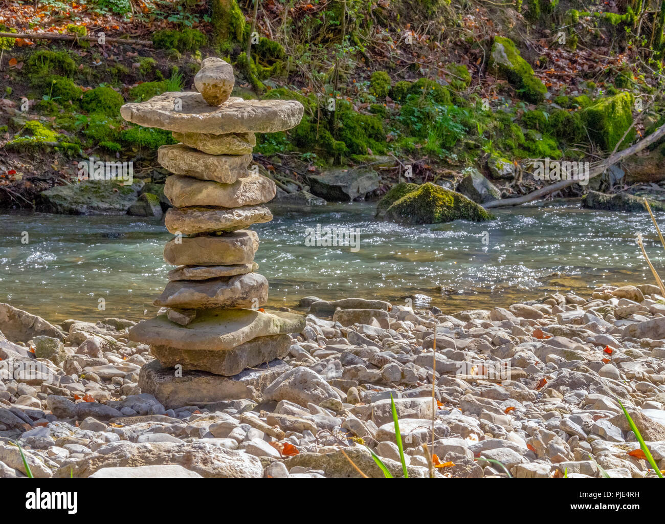 riverside scenery including a small tower build with flat pebbles Stock ...