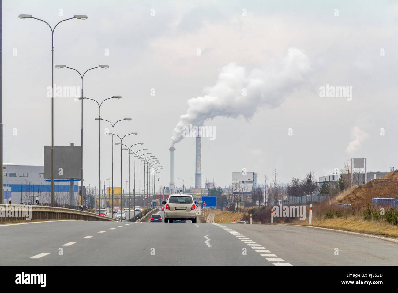 road scenery on a highway including a factory Stock Photo - Alamy