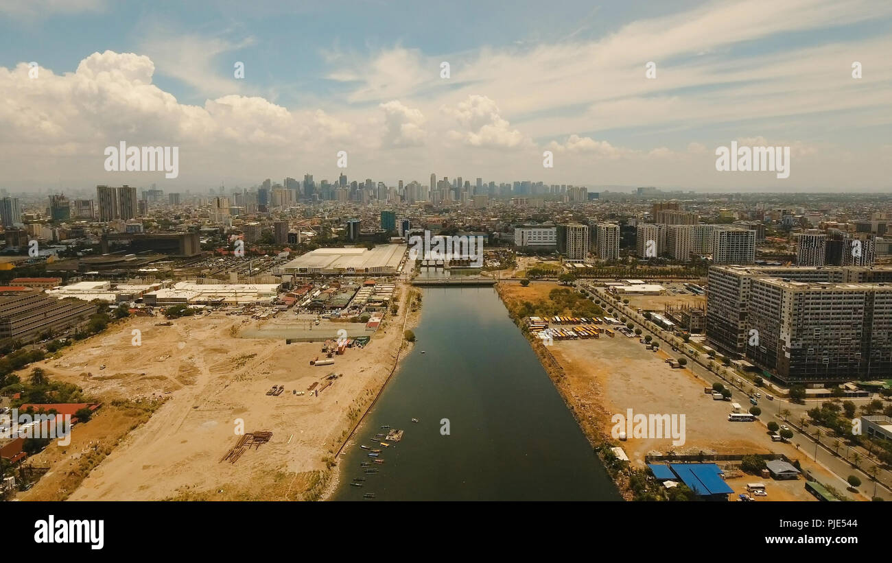 Aerial view of Manila city. Fly over city with skyscrapers and ...