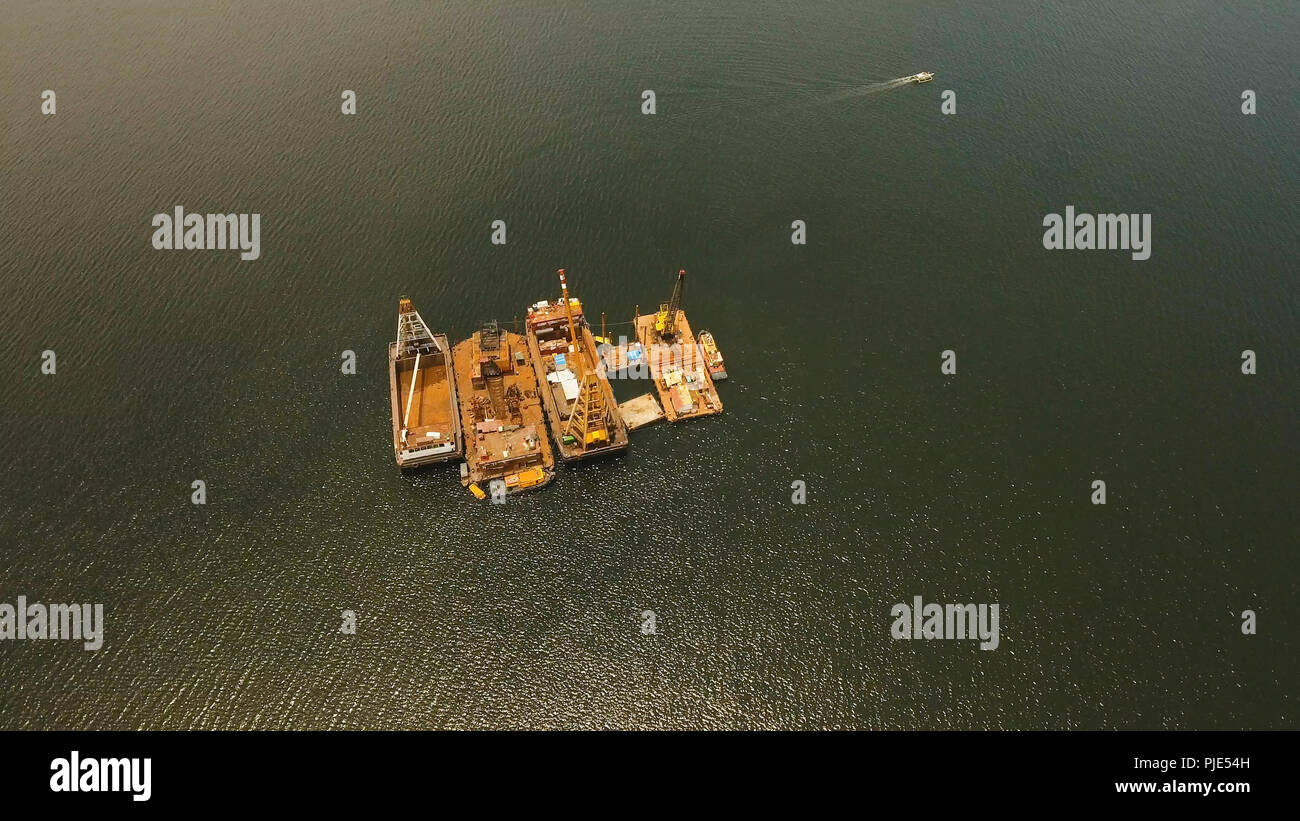 Dredge ship presumably performing harbor and channel maintenance. Aerial view: Huge crane barge ...