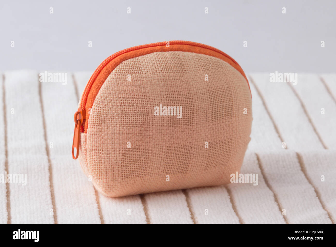 Fabric purse for coins on white cloth background Stock Photo - Alamy
