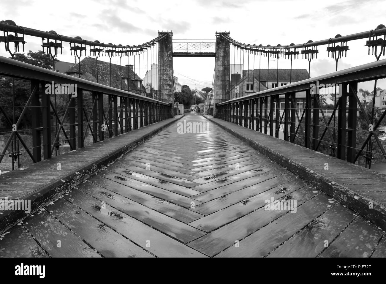 Wooden bridge crossing the sea to Bono village in France Stock Photo ...
