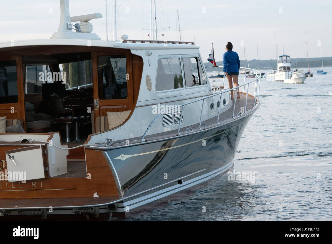 Luxury boat with women on bow overlooking Watch Hill Harbor Stock Photo ...