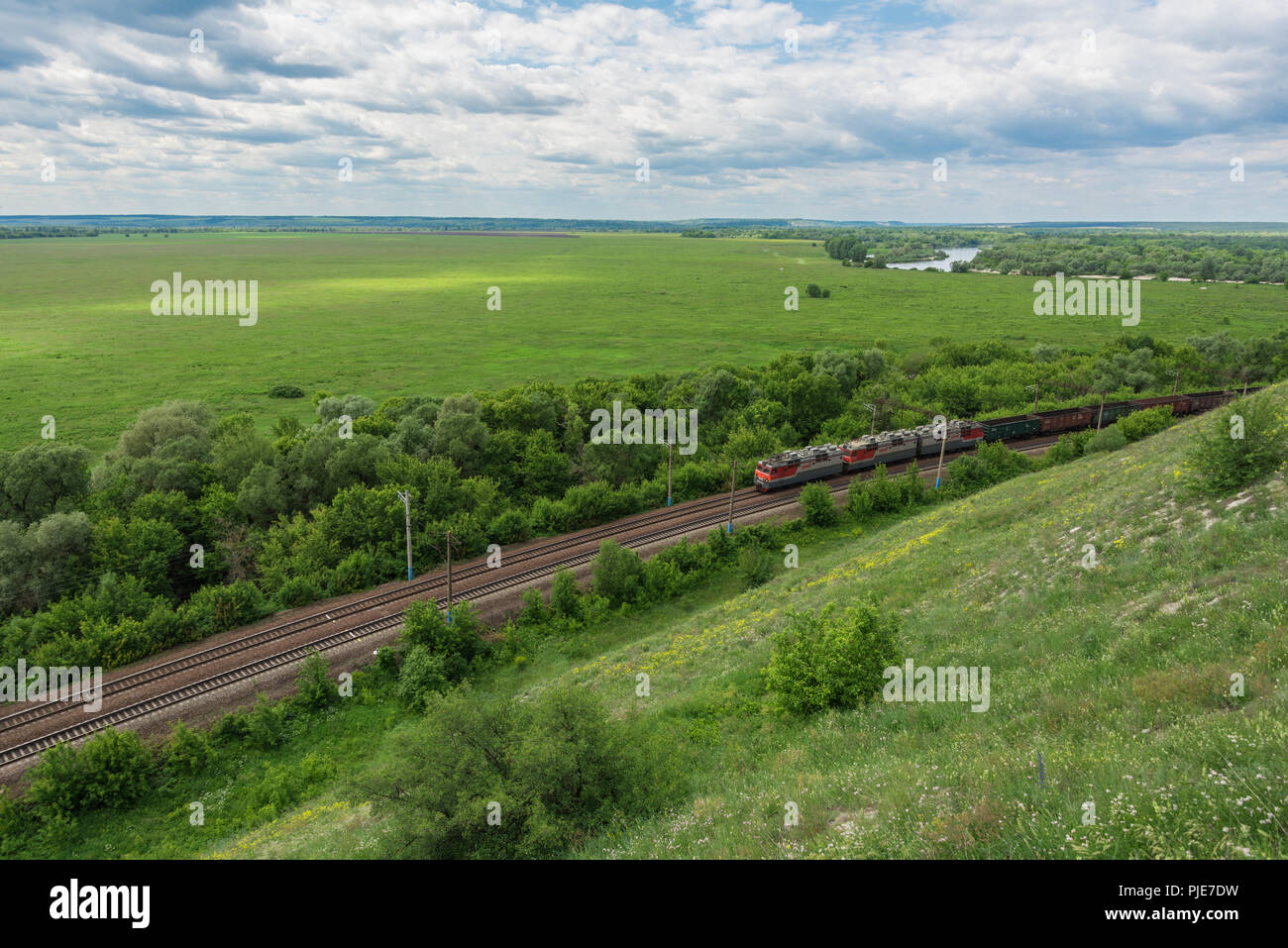 Freight train with locomotives passing by rail in Russia, along the ...