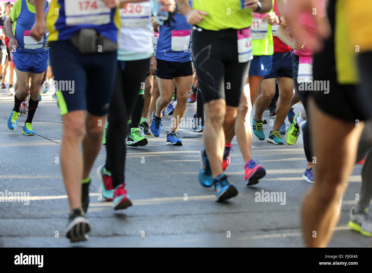 Marathon running race. Legs and bodies only. Unrecognizable people. The ...