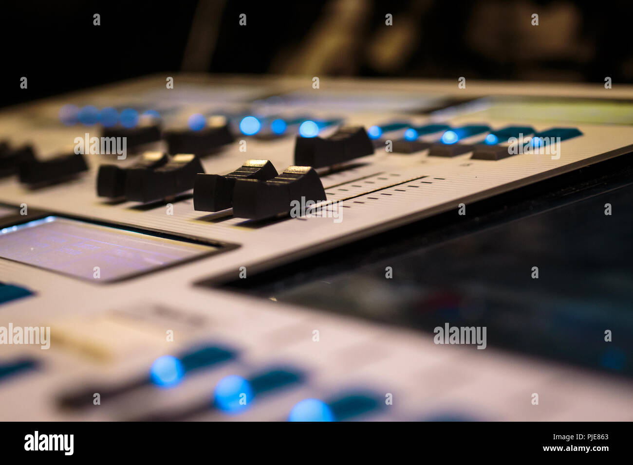 Closeup low view of Professional Lighting Designers Programming Console ...