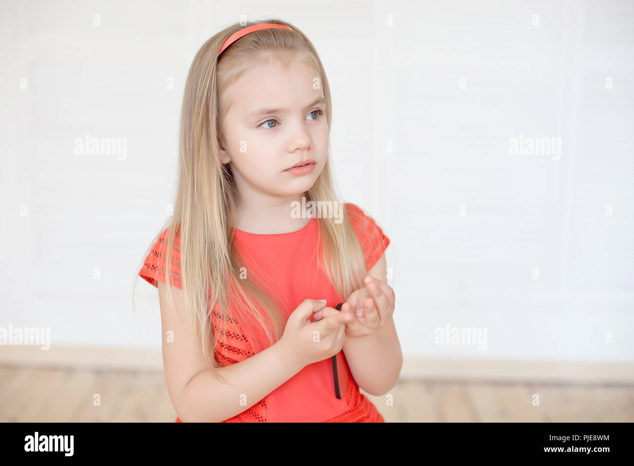 Little caucasian girl thoughtful counting her fingers indoors Stock ...