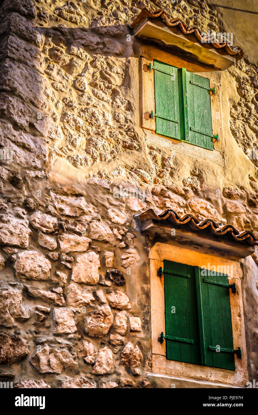 Window shutters on a Croatian home along narrow streets in the small ...