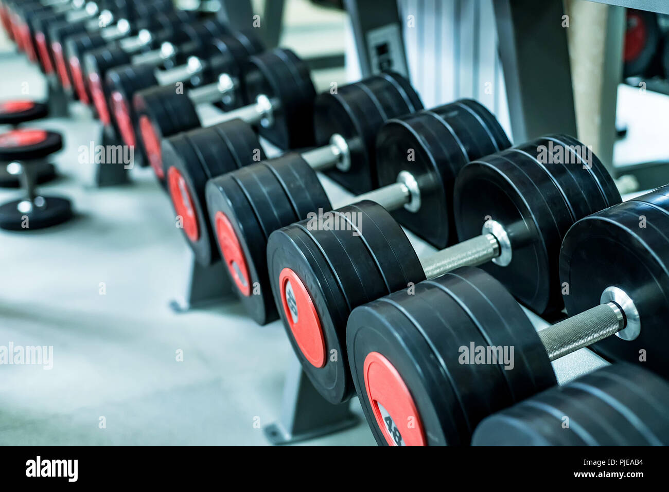 Close up image of chrome dumbbells in gym Stock Photo - Alamy