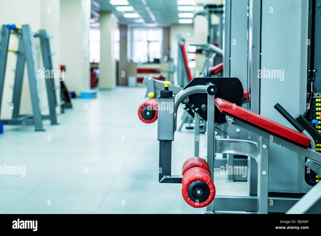 New fitness machines in modern gym interior Stock Photo - Alamy