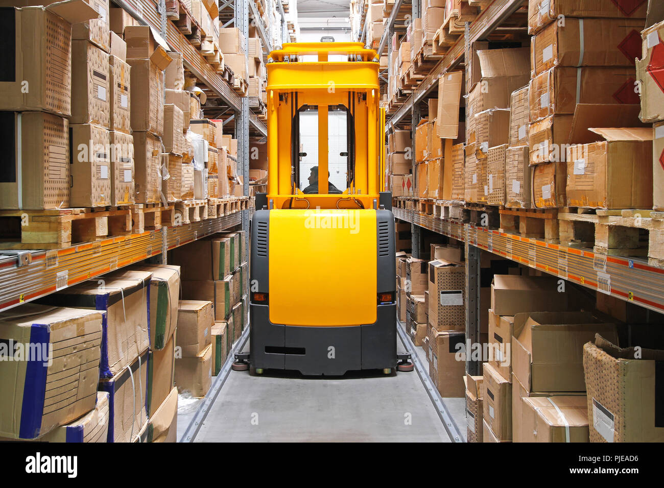 High rack stacker forklift truck in warehouse row Stock Photo - Alamy