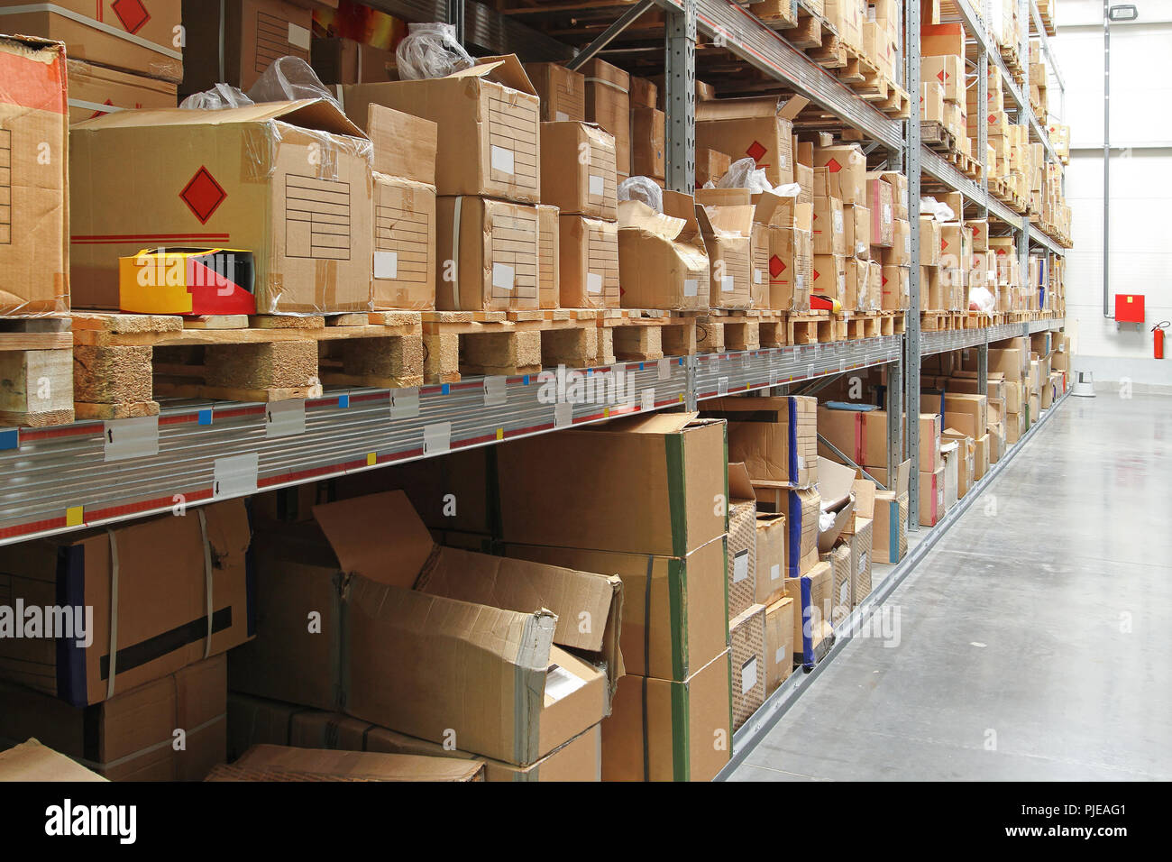 Warehouse shelf with cardboard boxes and goods Stock Photo - Alamy