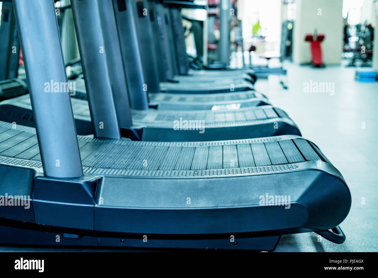 Empty treadmills set in gym interior close Stock Photo - Alamy