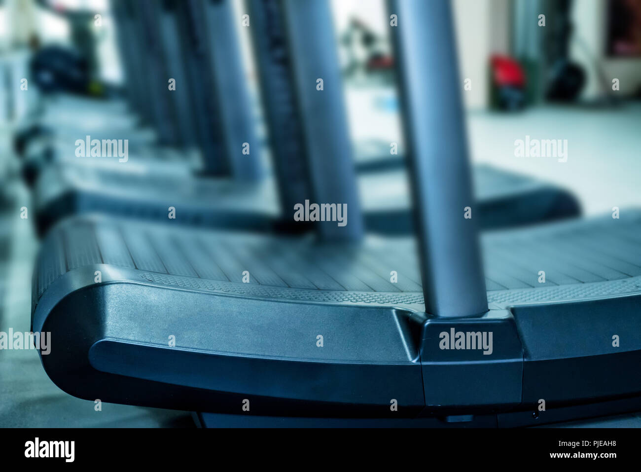 Blurred empty treadmills set in gym interior close Stock Photo - Alamy