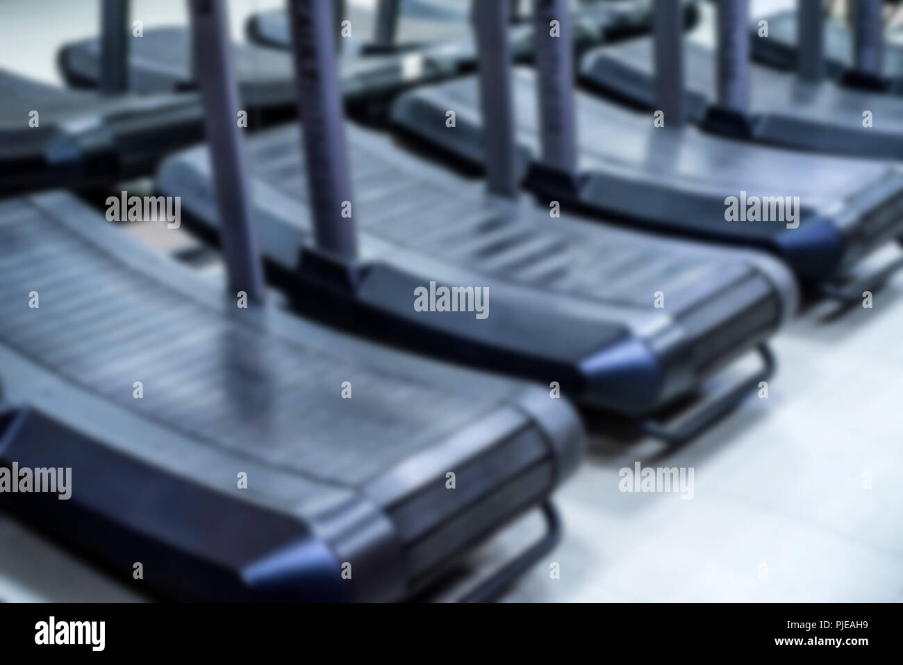 Blurred empty treadmills set in gym interior close Stock Photo - Alamy