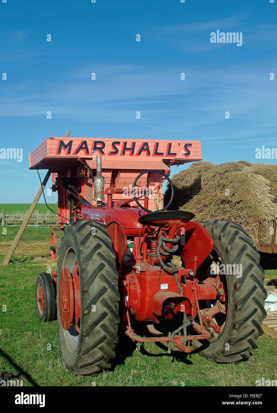 Farmal Model M and threshing machine Stock Photo - Alamy