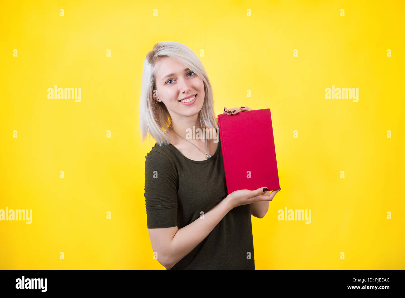 Cheerrful woman autor of a book at the presentation showing the book ...