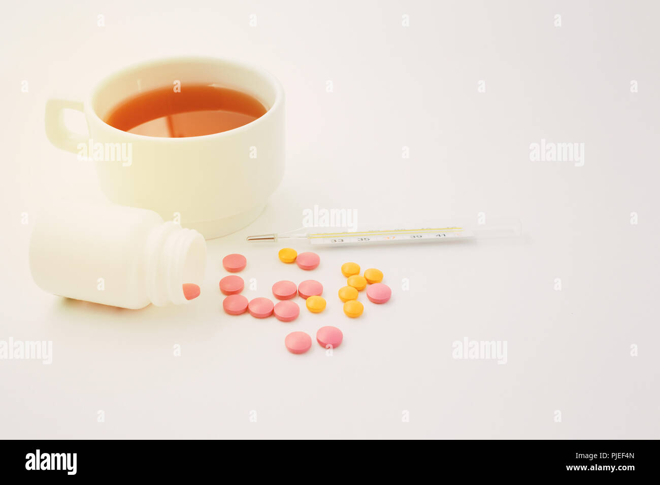 on a white background thermometer, rose tablets and tea Stock Photo - Alamy