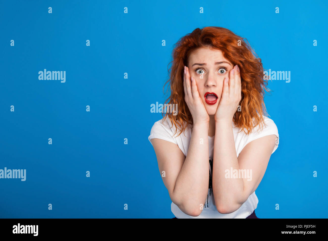 confused red-haired girl in the style of punk. Emotional concept. On ...