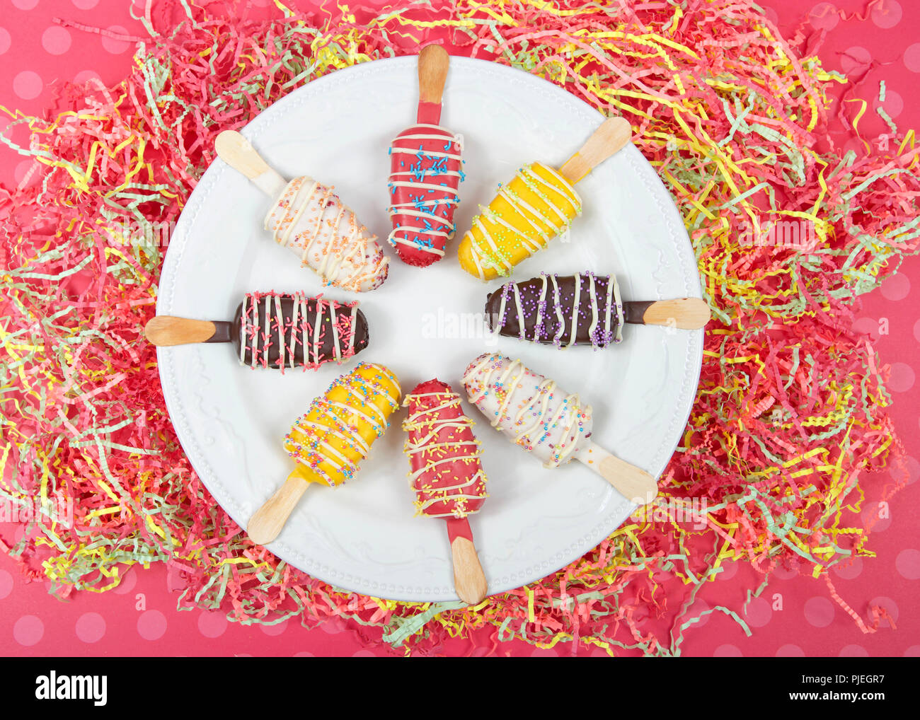 Multiple colored candy stripped popsicle cake pops with sprinkles on ...