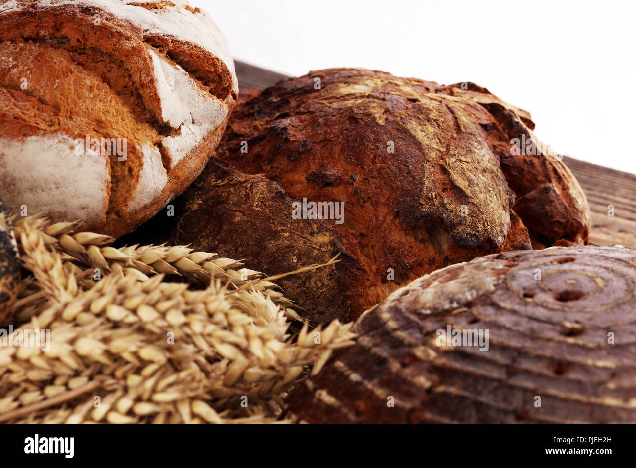 Different kinds of bread and bread rolls on board from above. Kitchen ...