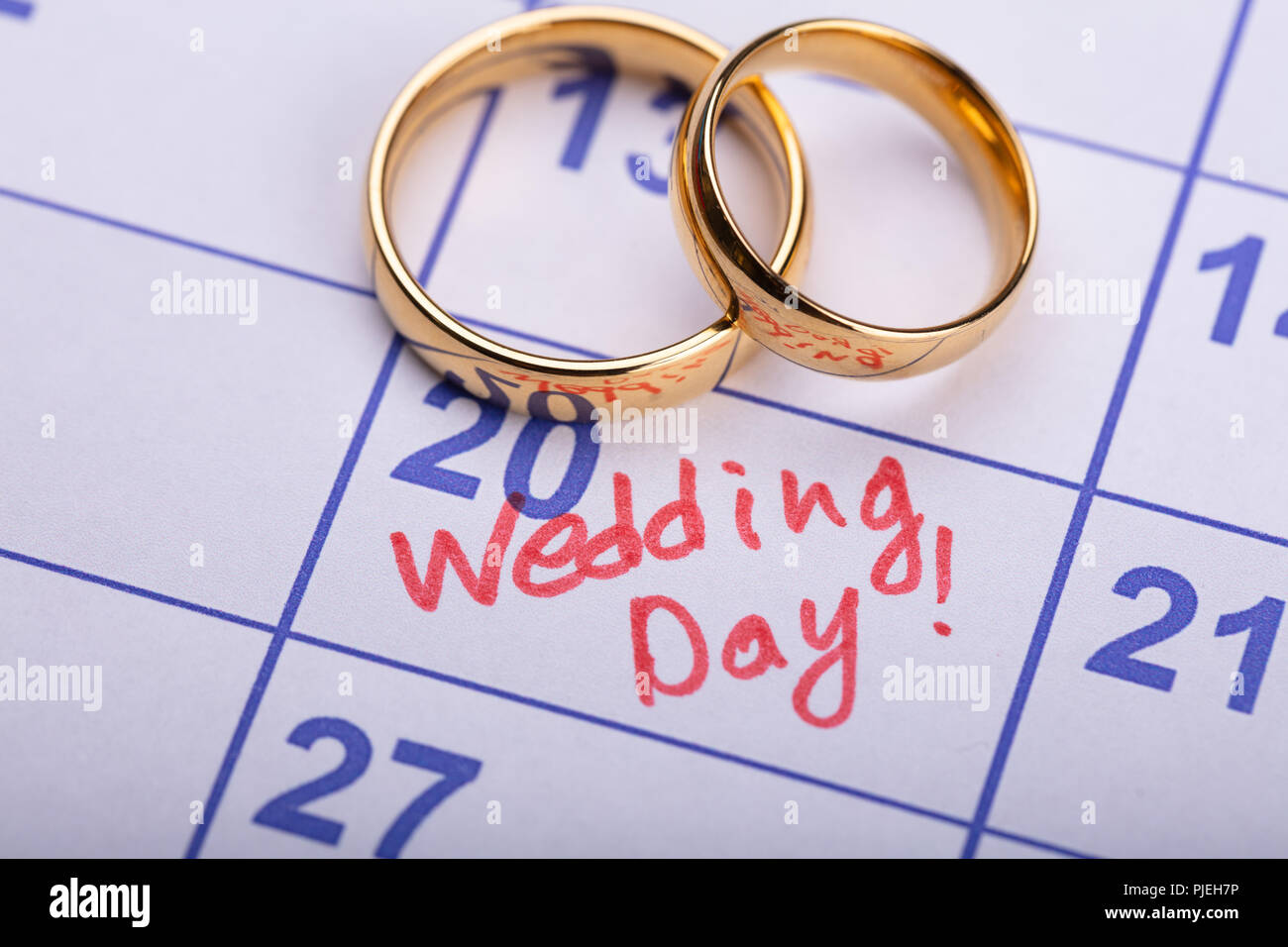 Two Golden Rings On Calendar With Red Wedding Day Text Stock Photo - Alamy