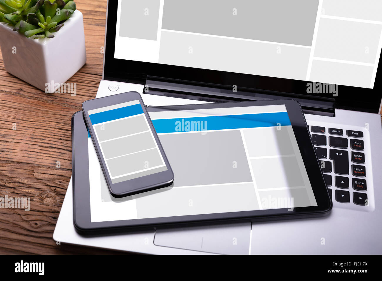 Electronic Devices With Screen On Wooden Desk Near Diary And Pen Stock ...