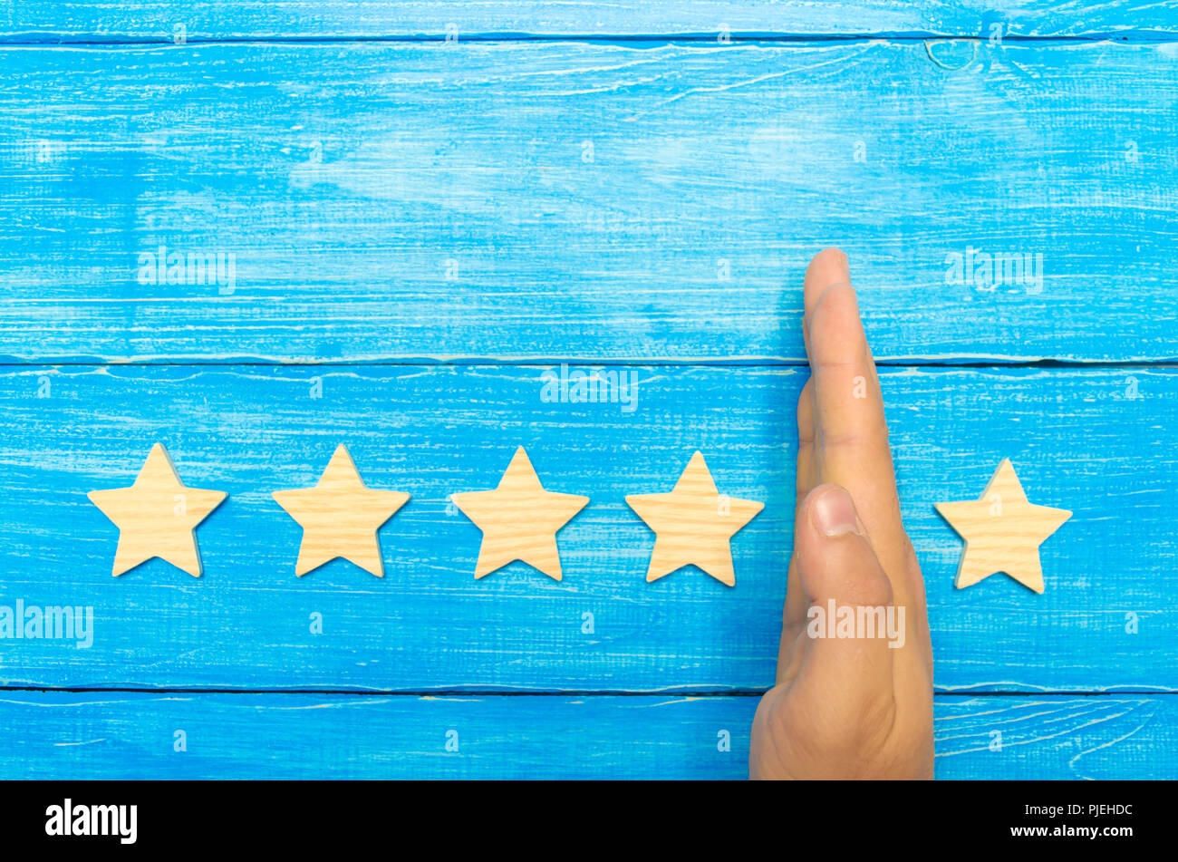 hand of the businessman separates the fifth star from the other four ...