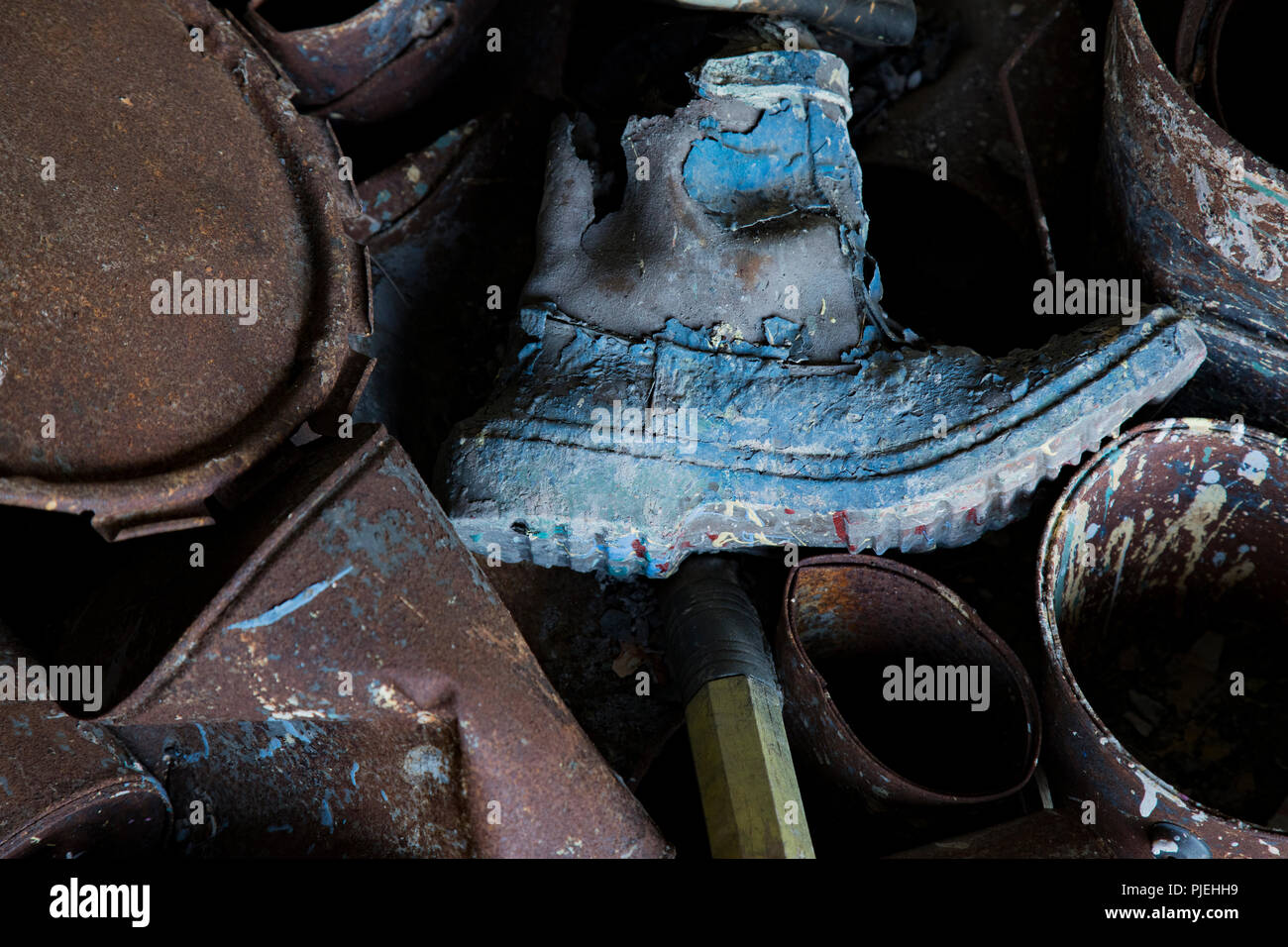Old work boot amongst rusted paint cans in Provence France Stock Photo ...