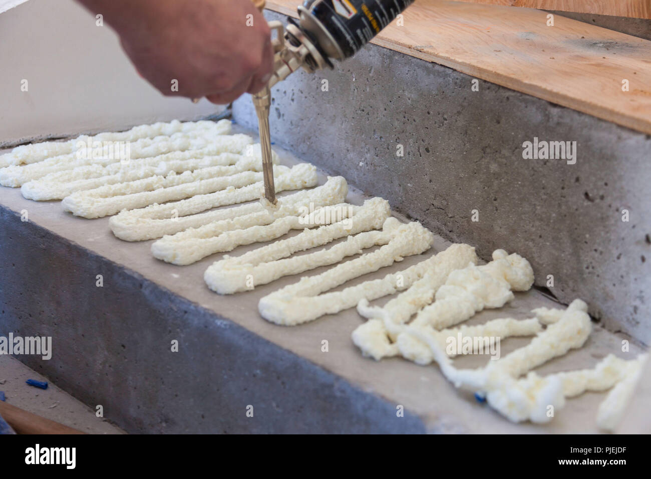 Production and installation of flax. Work of the master Stock Photo - Alamy