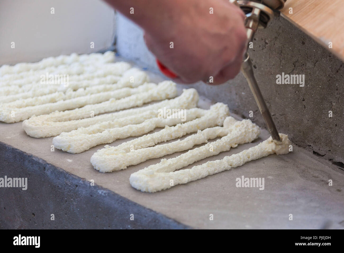 Production and installation of flax. Work of the master Stock Photo - Alamy